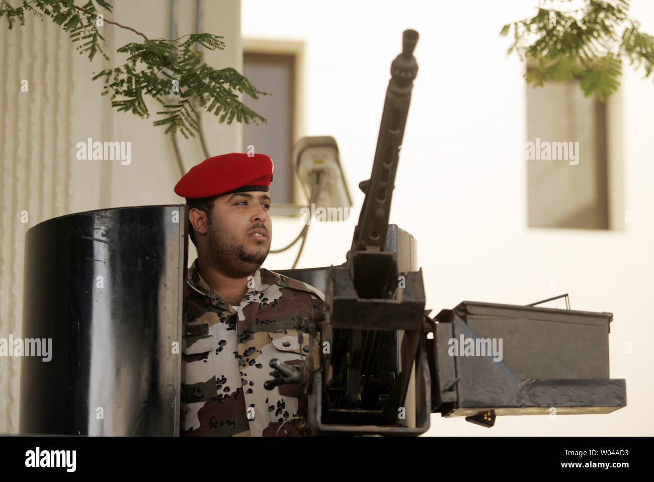 A Saudi security soldier stands guard behind an anti-aircraft in Mina ...