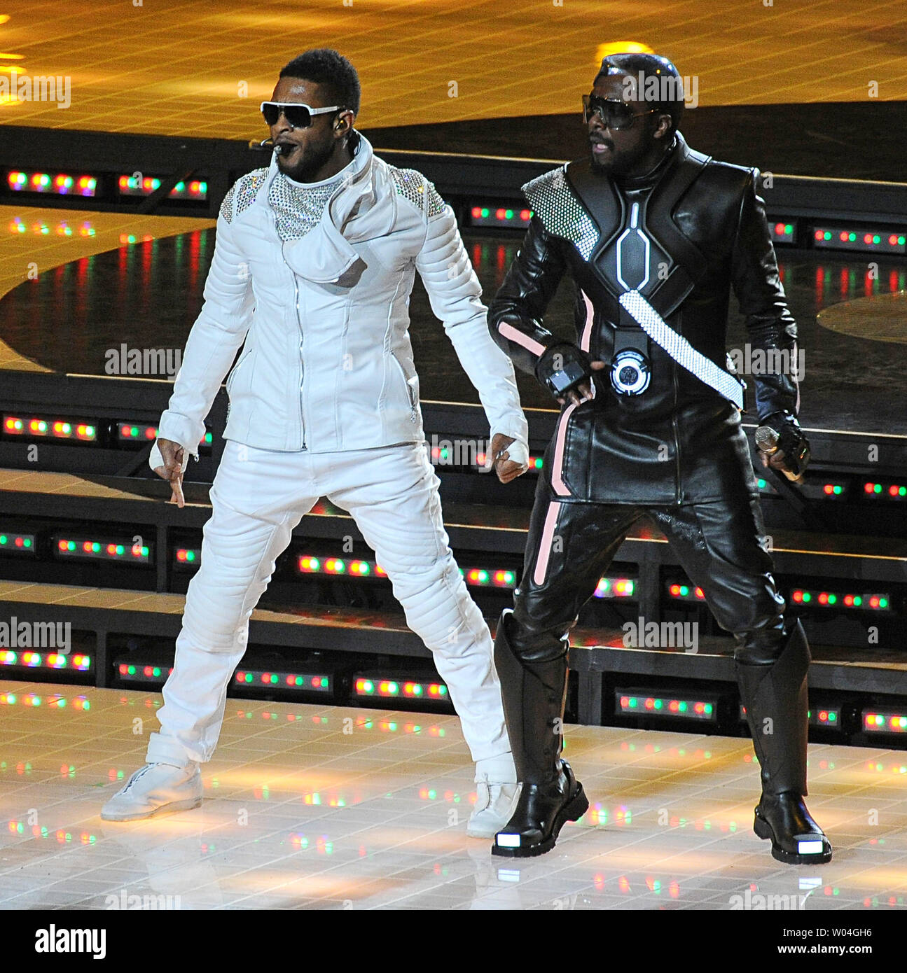 Usher (L) and Will.I.Am of The Black Eyed Peas perform during halftime ...