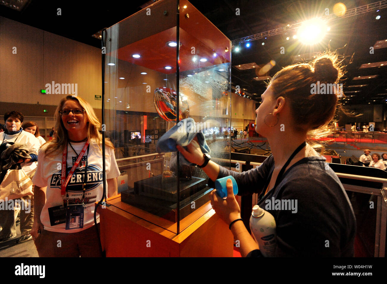Maria Porter, of Indianapolis, cleans the glass as NFL fans line up to ...