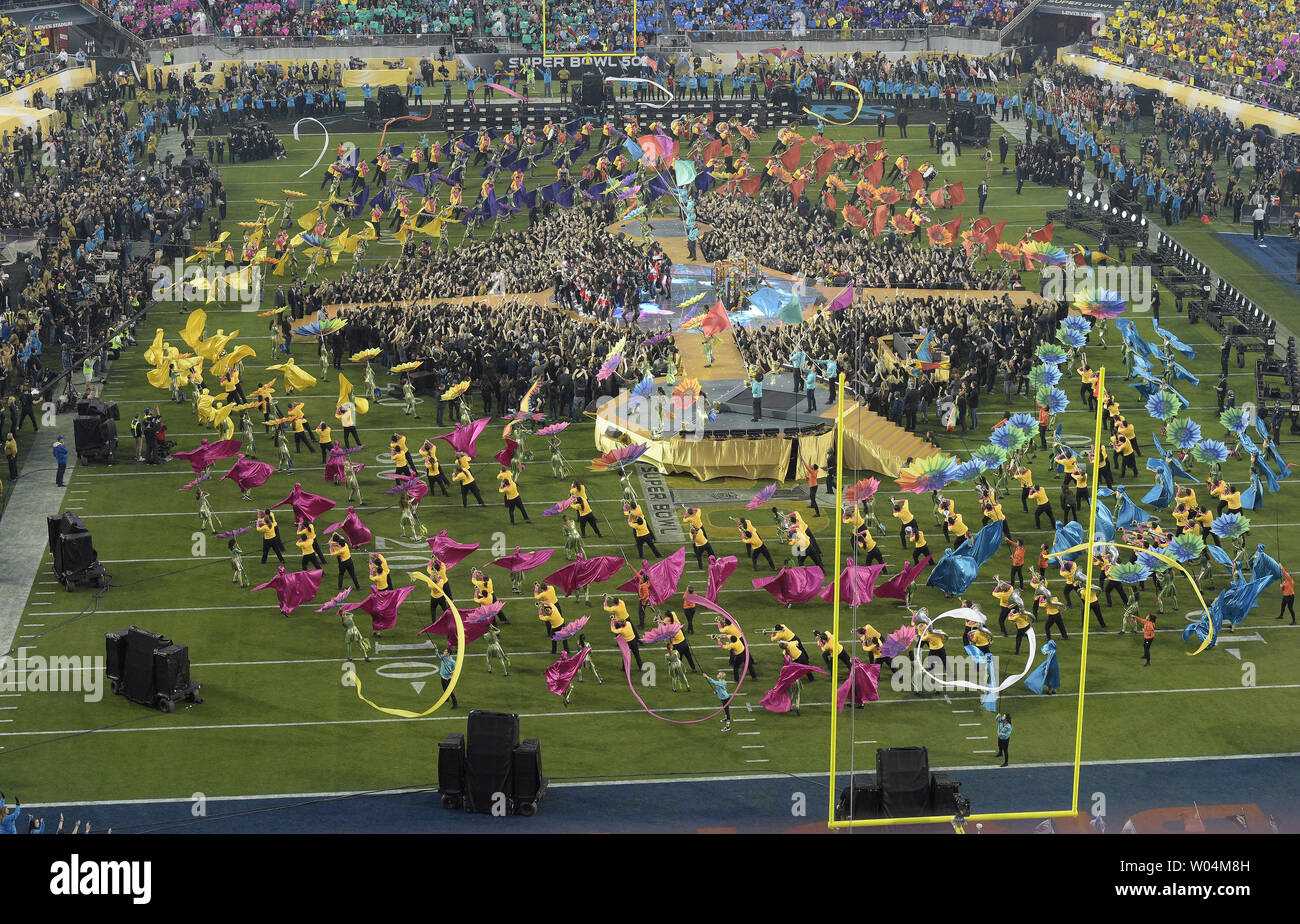 Performers wave multicolored flags during the Super Bowl 50 halftime ...