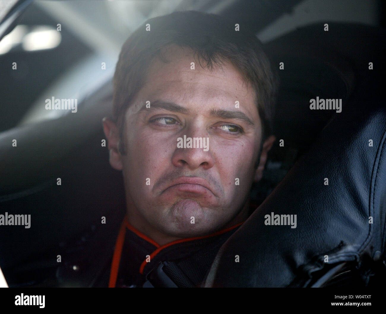 Race car driver David Stremme settles into his race car before NASCAR ...