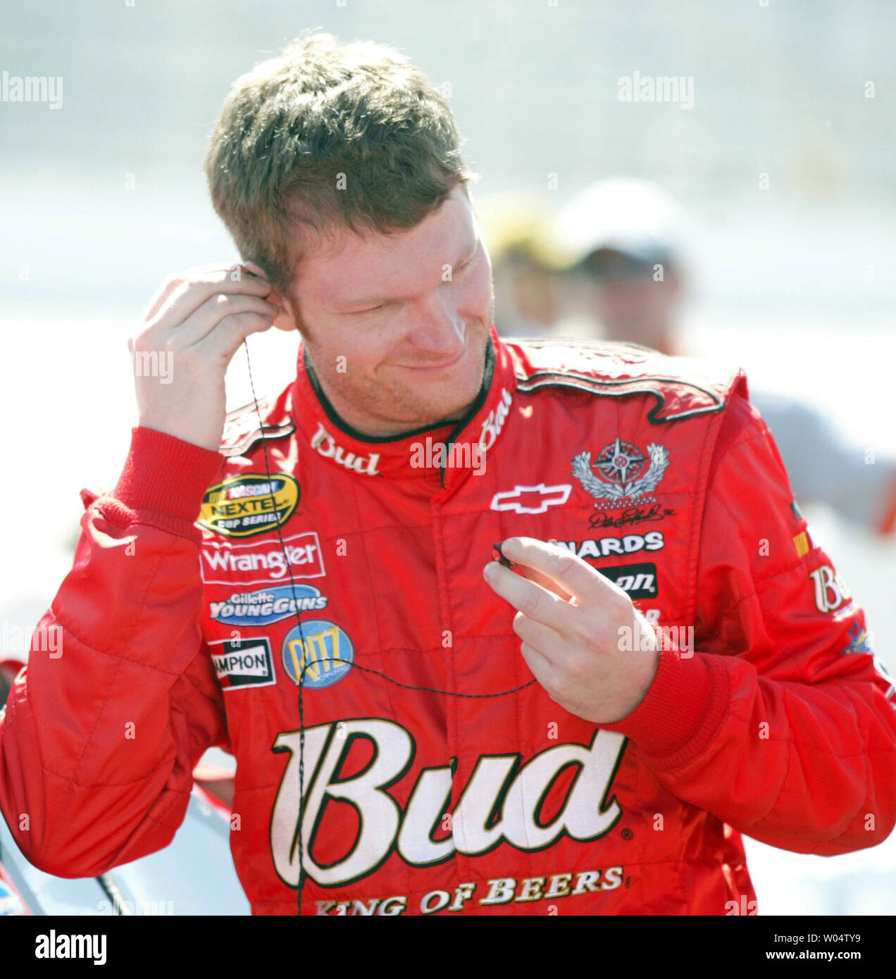 Race car driver Dale Earnhardt, Jr puts in his earpiece before NASCAR ...