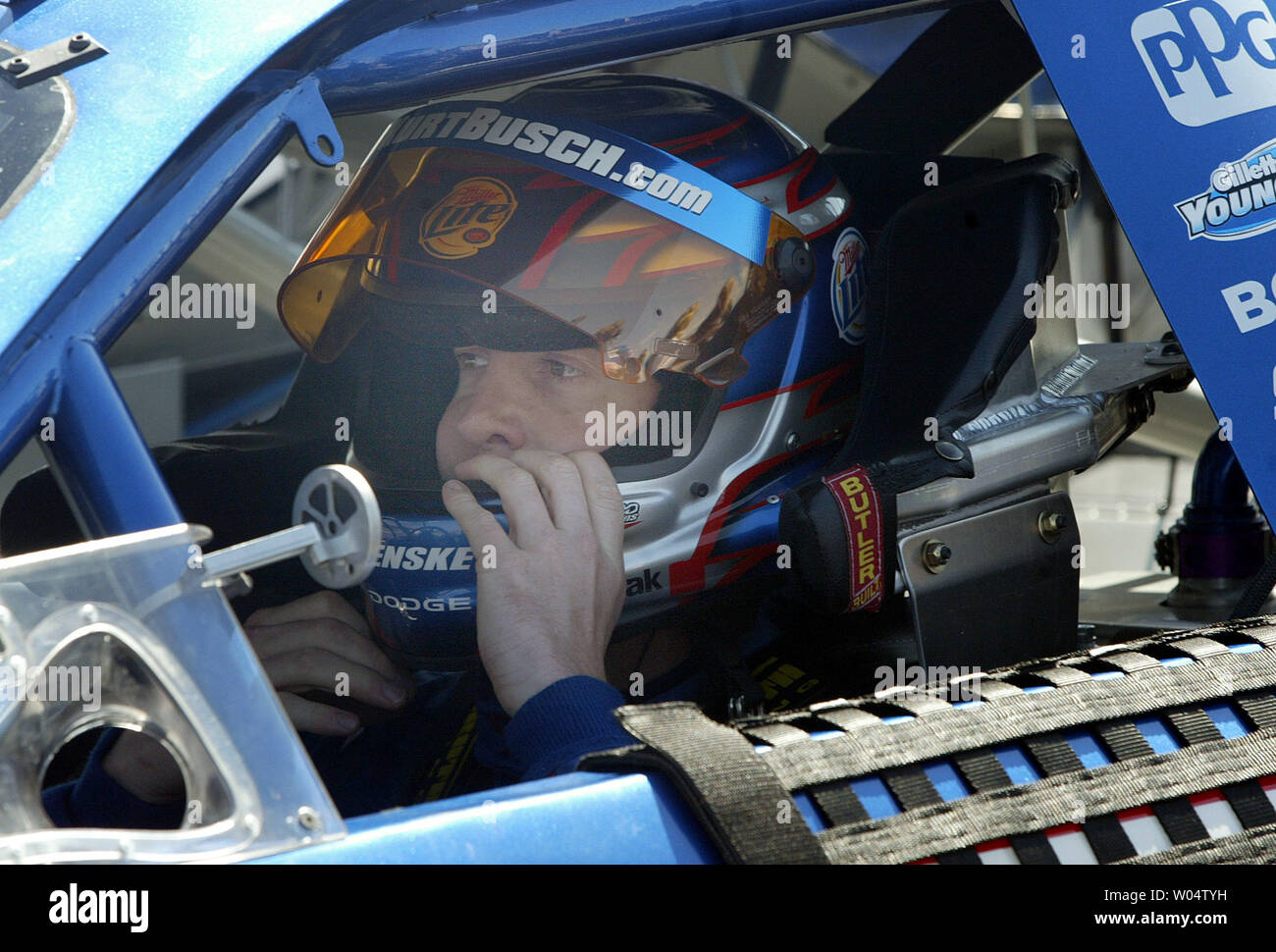 Race car driver Kurt Busch settles into his car as he awaits his turn ...