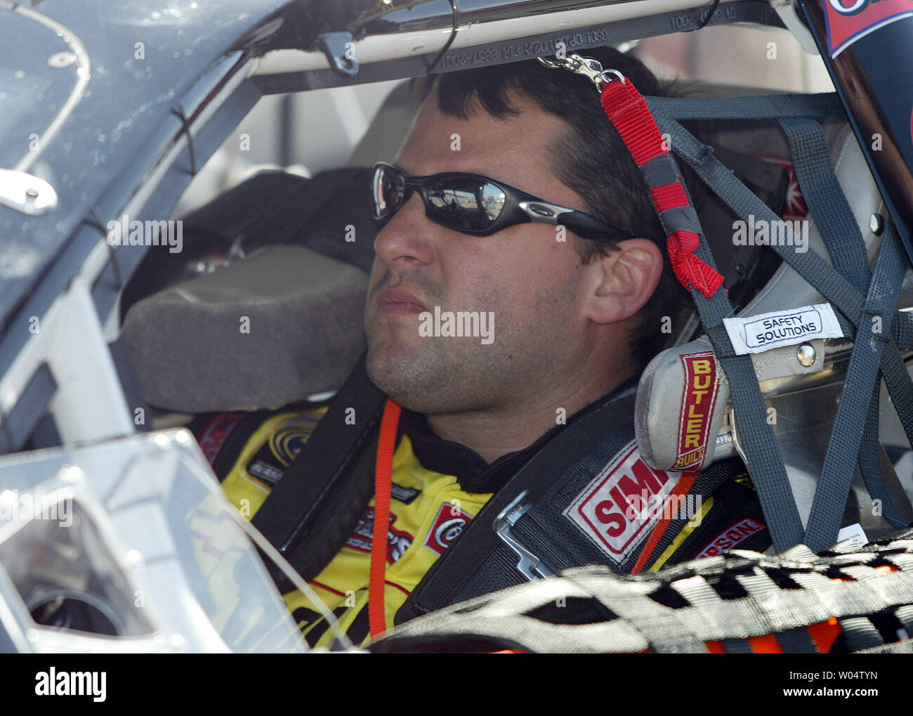 Race car driverTony Stewart sits in his car as he awaits his turn on ...