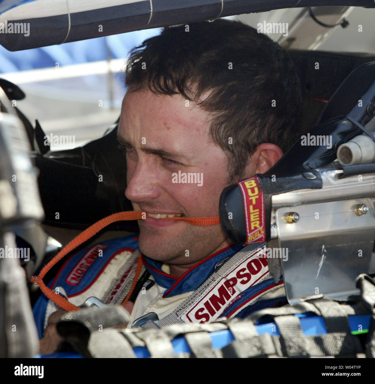 Race car driver Scott Wimmer sits in his car as he awaits his turn on ...