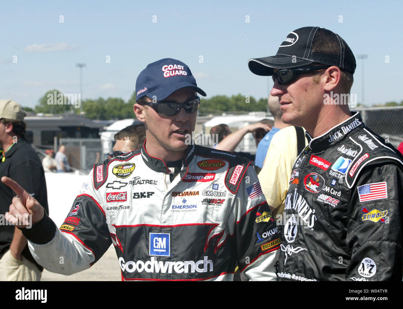 Race car drivers Kevin Harvick, left, and Clint Bowyer talk on pit road ...