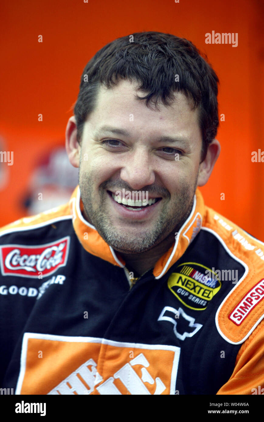 Race car driver Tony Stewart laughs as he waits on pit road before the ...