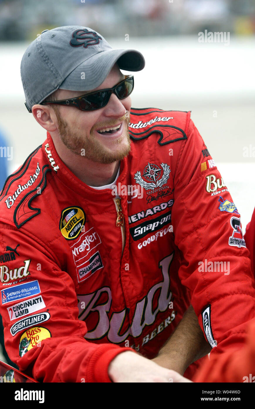 Race car driver Dale Earnhardt Jr. laughs as he waits on pit road ...