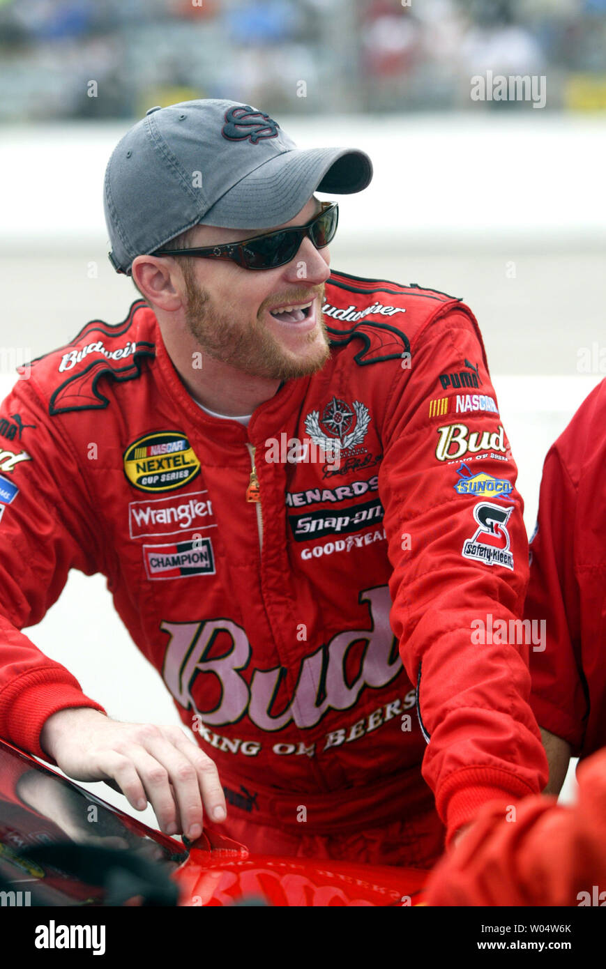 Race car driver Dale Earnhardt Jr. laughs as he waits on pit road ...