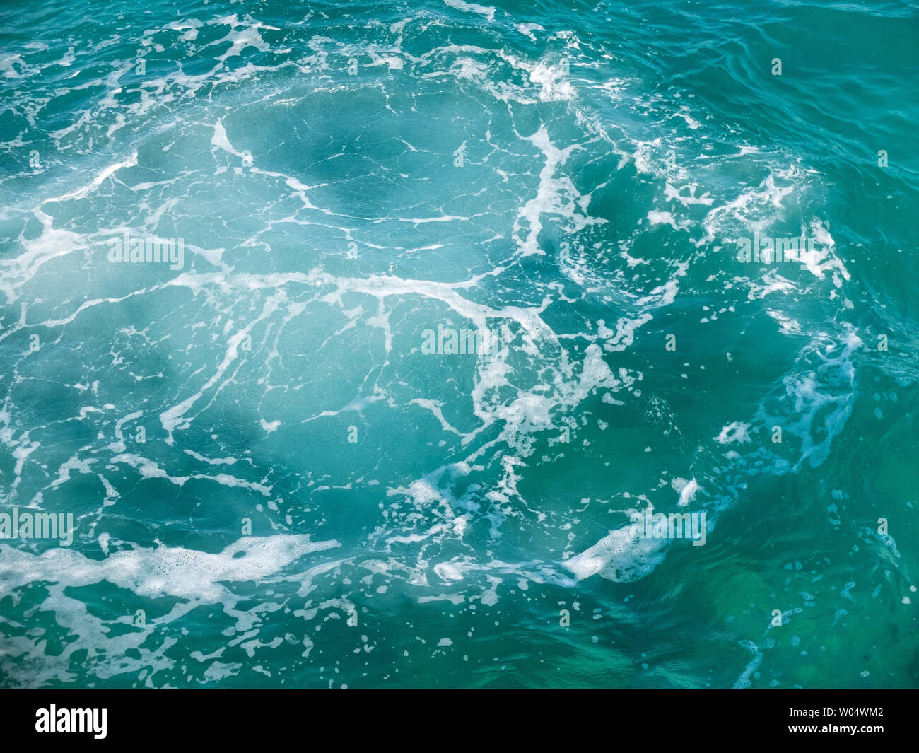 Splashing foamy waves on the sea surface Stock Photo - Alamy