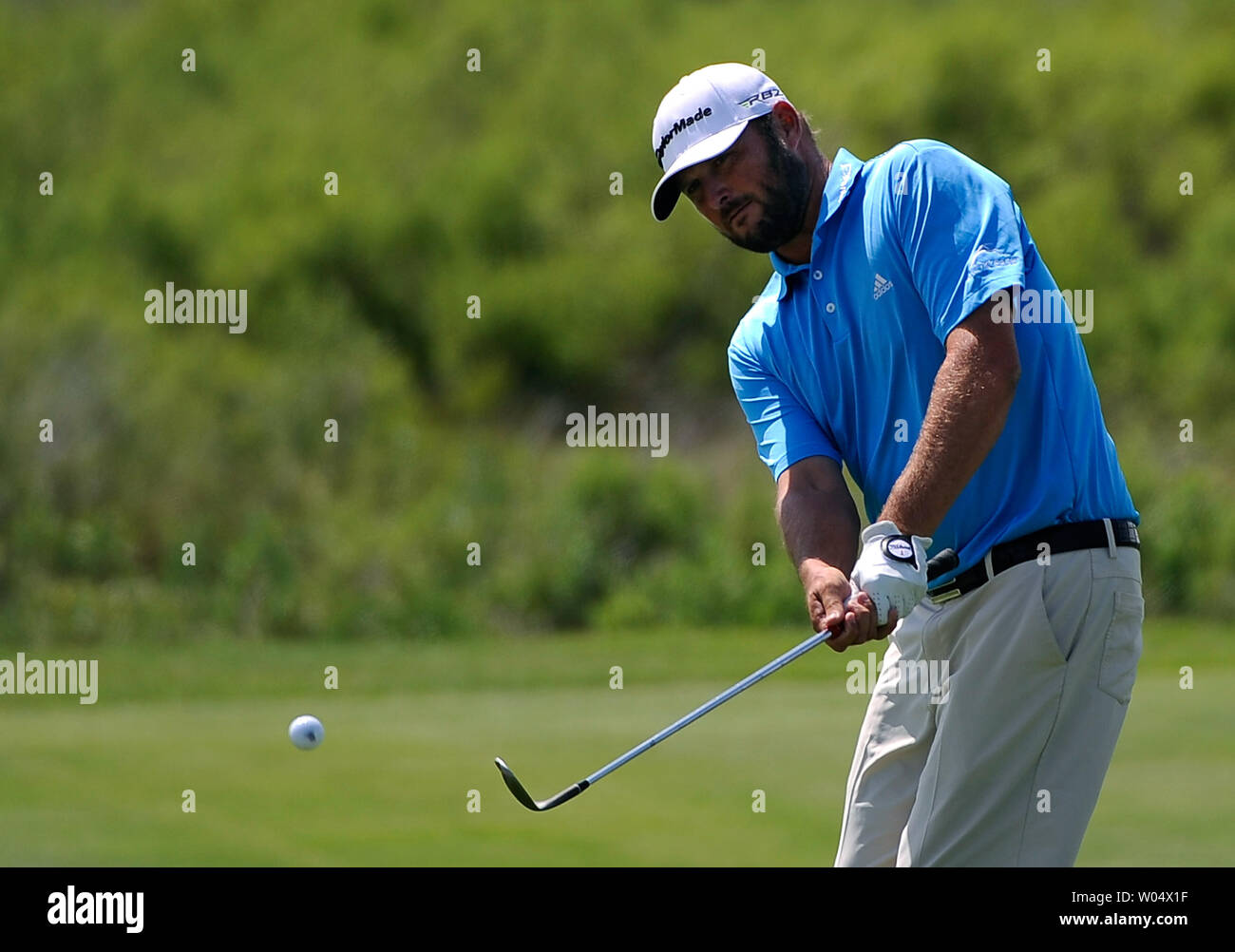 Blake Adams chips to hole four where he scores a bogey during the third ...