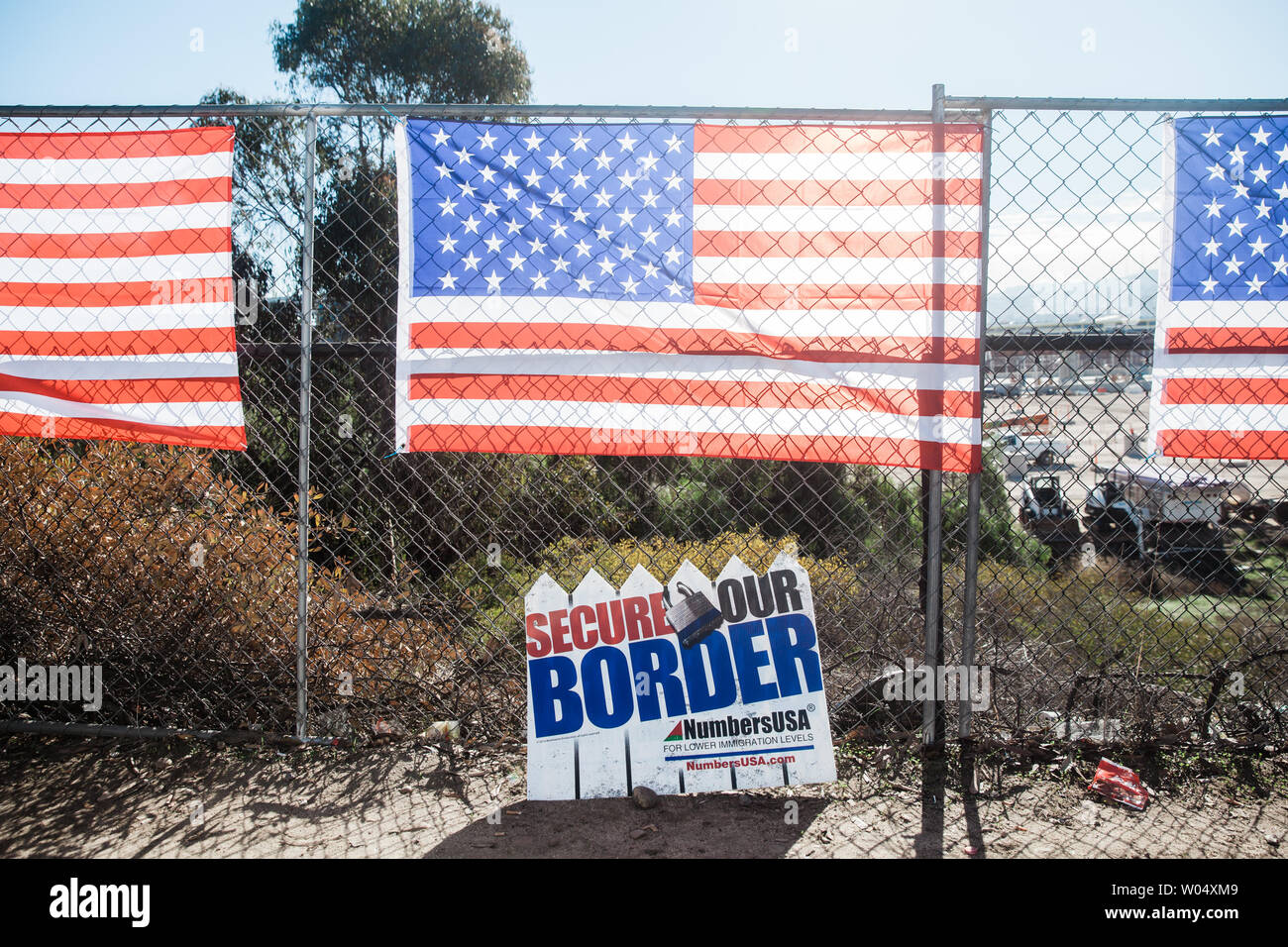 American flags hang on a fence during an "America First" rally at the ...