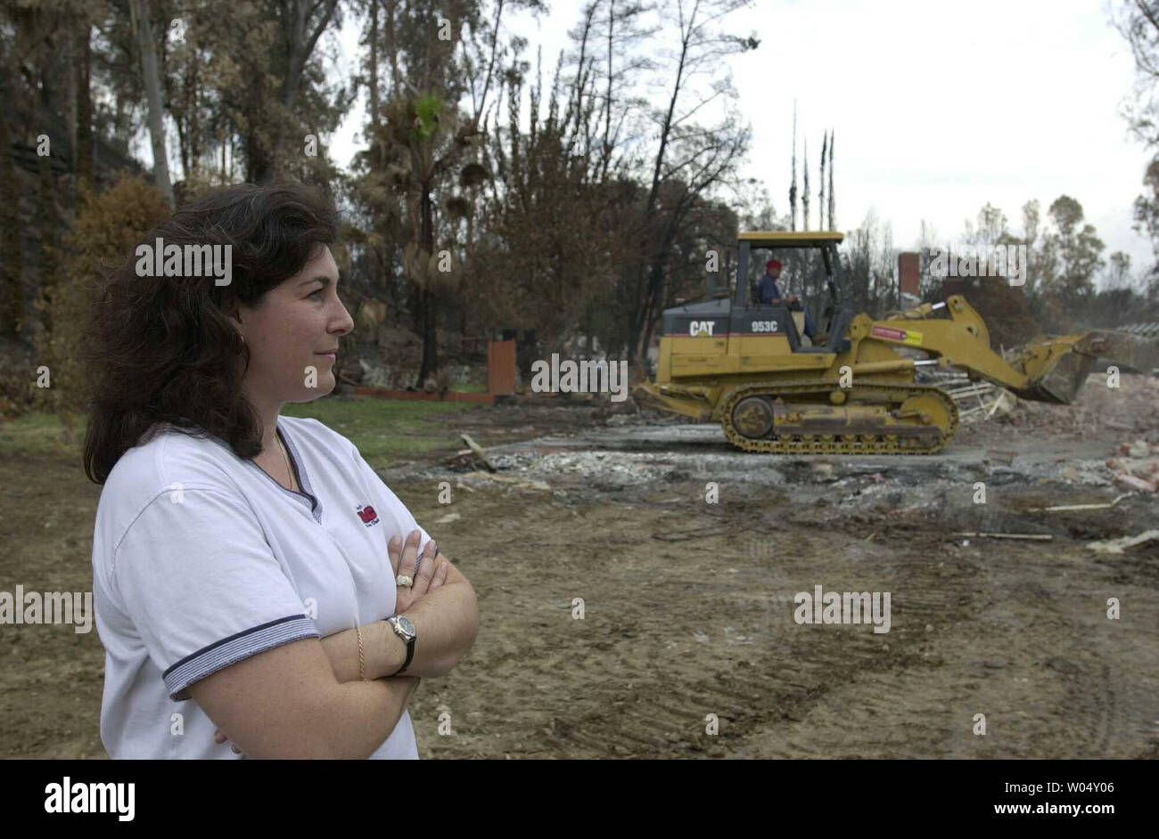 Fire victim Jordana Ryan, looks over the empty lot that was once her ...