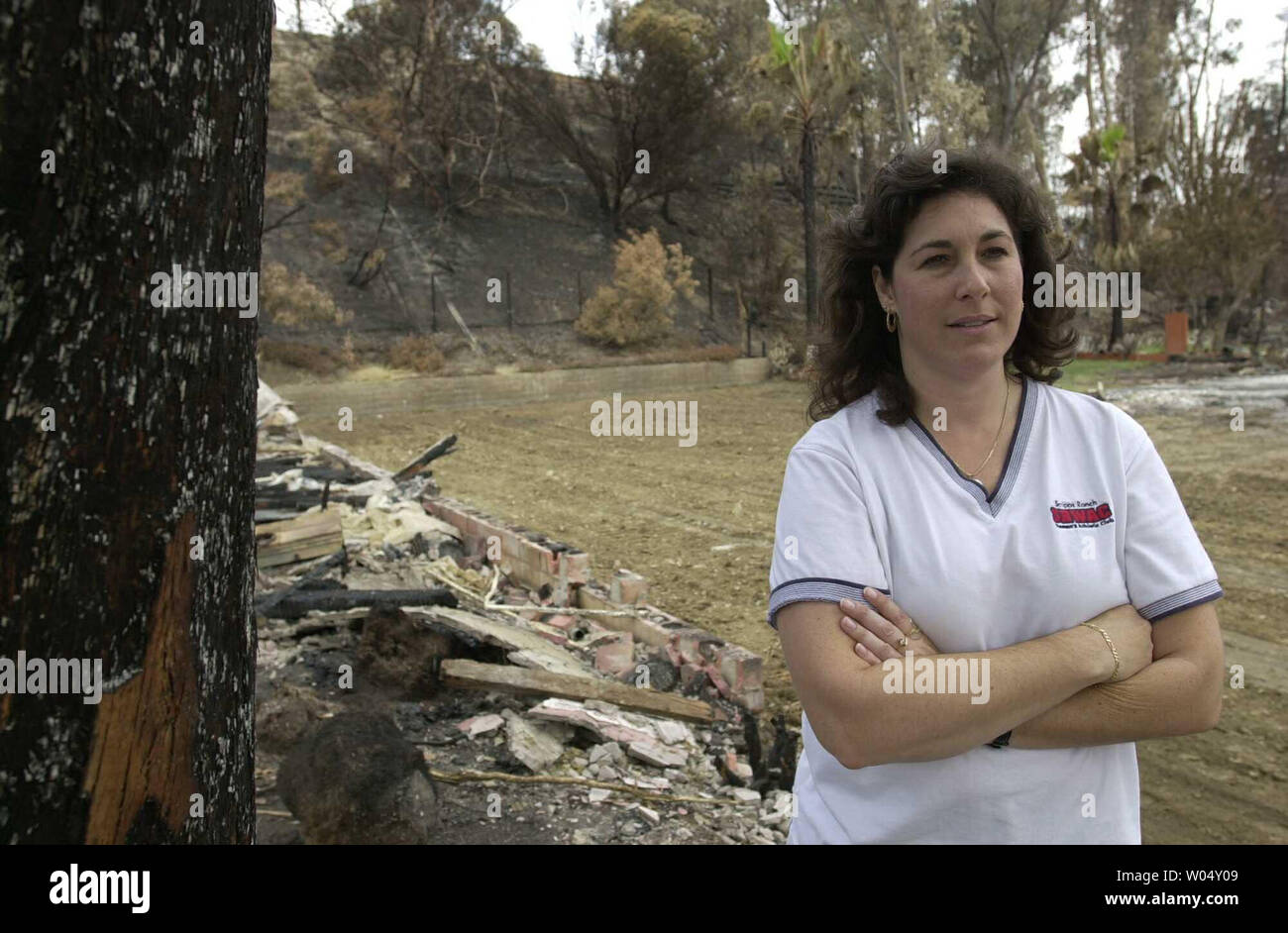 Fire victim Jordana Ryan, looks over the empty lot that was once her ...