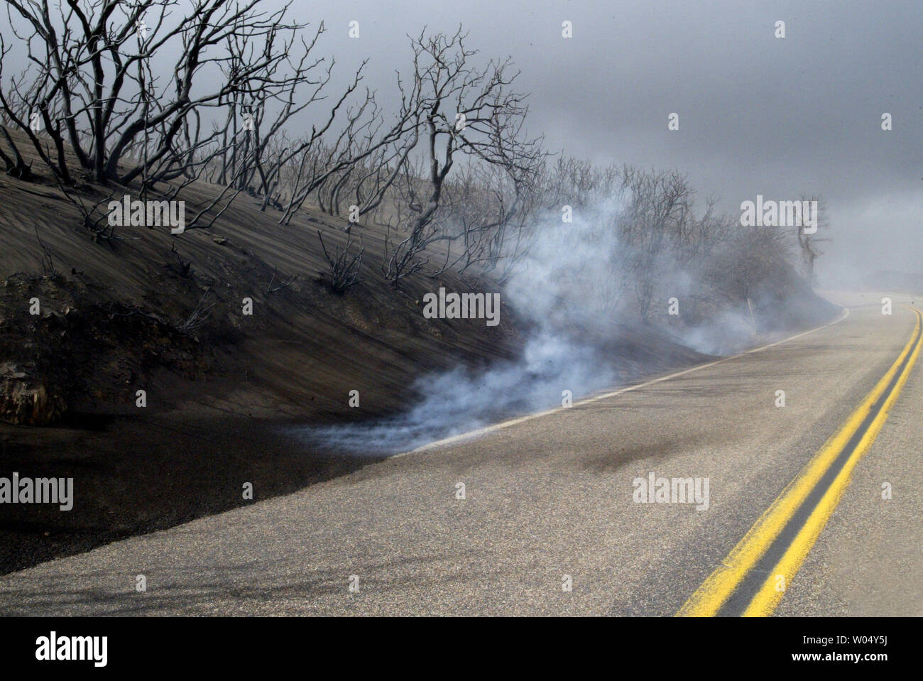 Smoke rises from burnt landscape on Sunrise Highway north of Mt Laguna ...