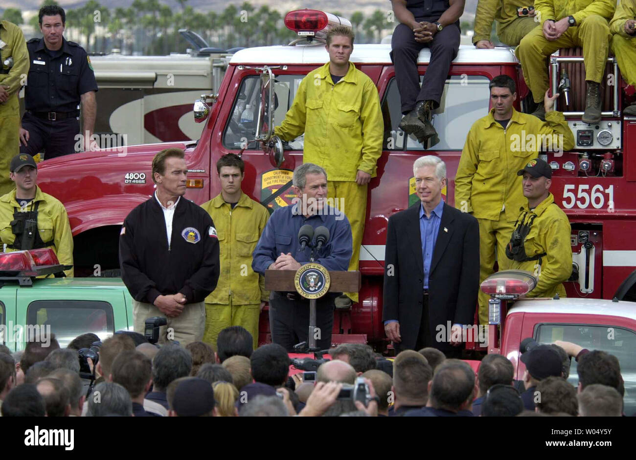 U.S. President George W. Bush speaks to firefighters from the back of a ...