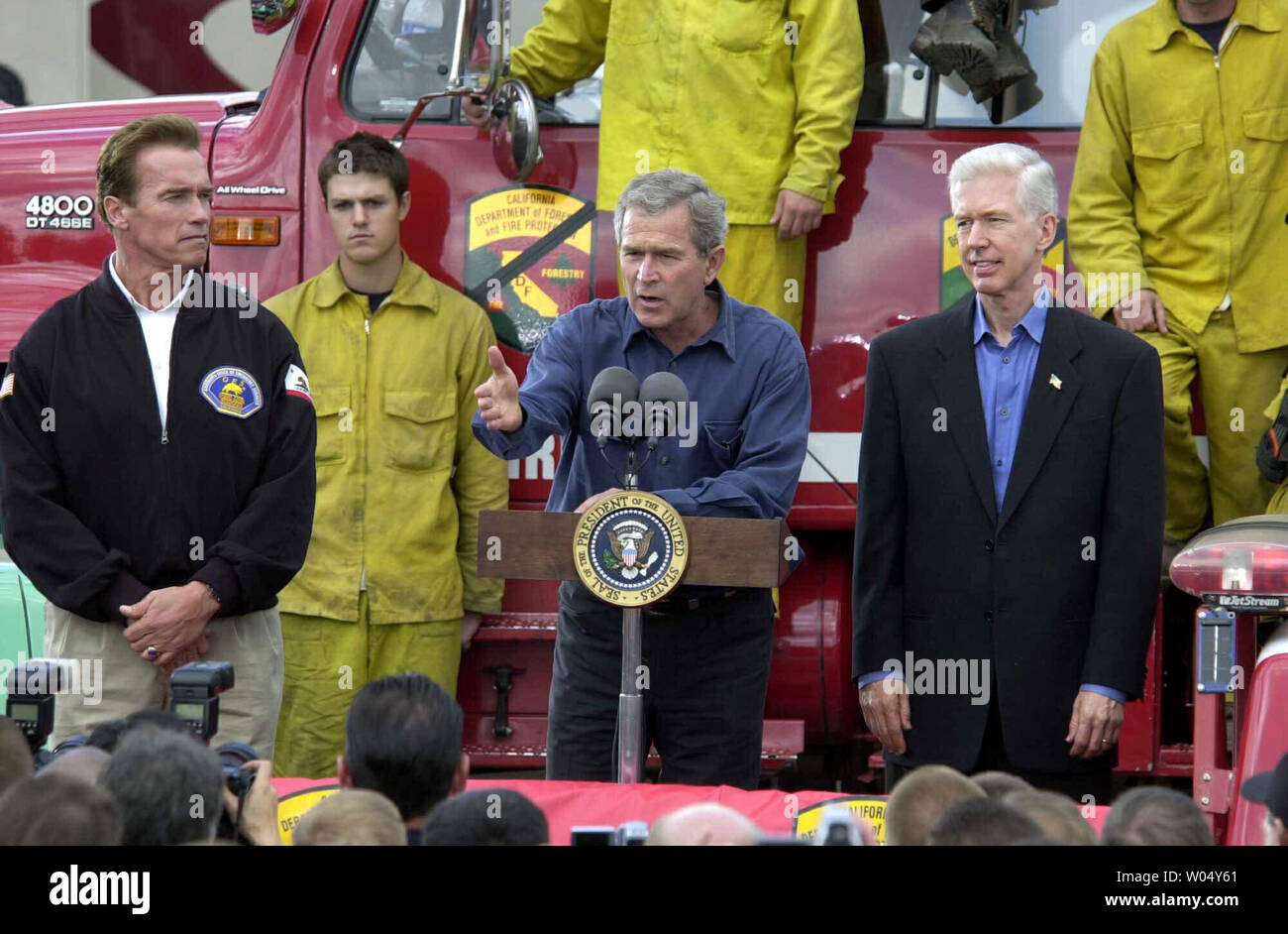 U.S. President George W. Bush speaks to firefighters from the back of a ...