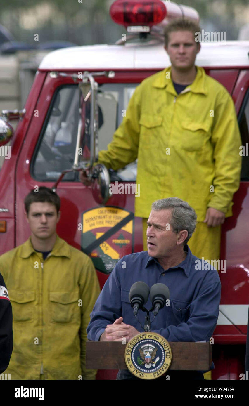 U.S. President George W. Bush speaks to firefighters from the back of a ...