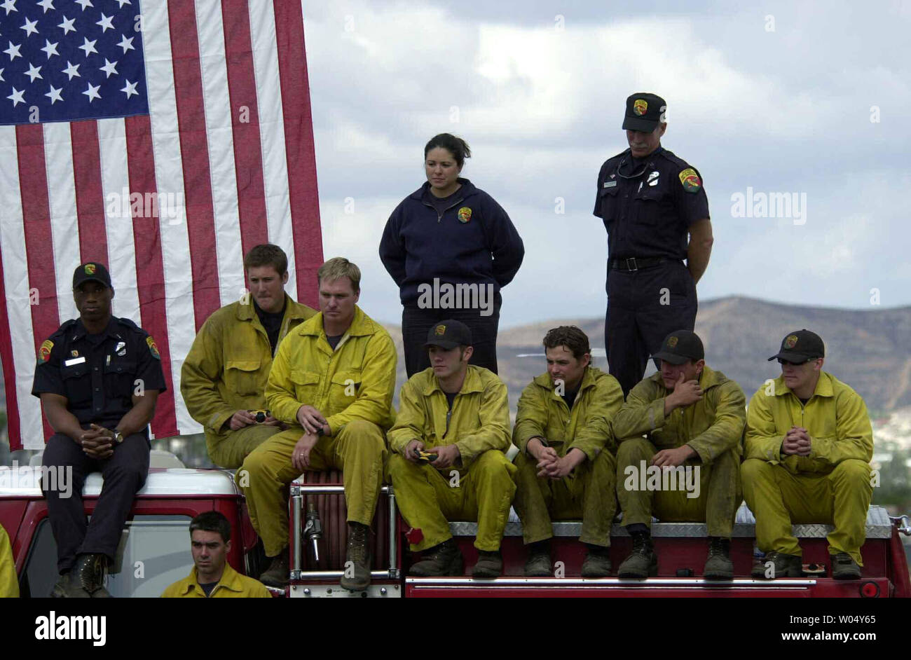 Firefighters look on from the top of a fire truck as U.S. President ...