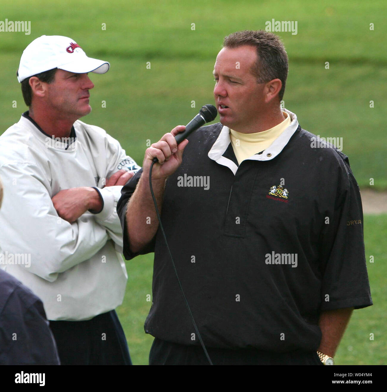 Football player Stan Humphries (R) congratulates baseballs Andy Van ...