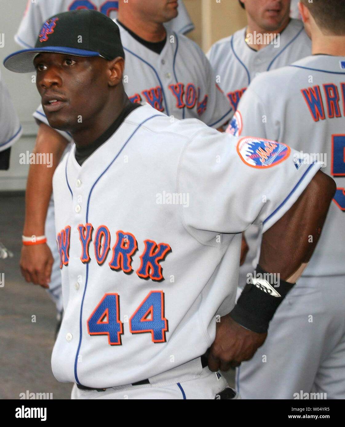 Mets right fielder Mike Cameron watches the action from the dugout as ...