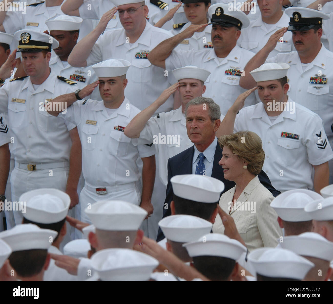 U.S. President George W. Bush and First Lady Laura Bush receive salutes ...