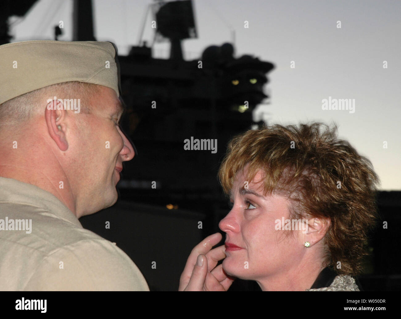 Senior Chief Tim Goode wipes a tear from his girlfriend Cydney Hill’s ...