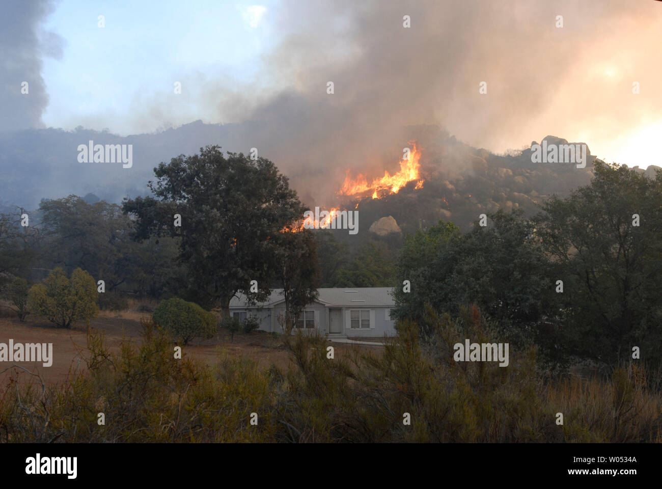 A wall of flames approaches homes near Deerhorn Valley, a community in ...