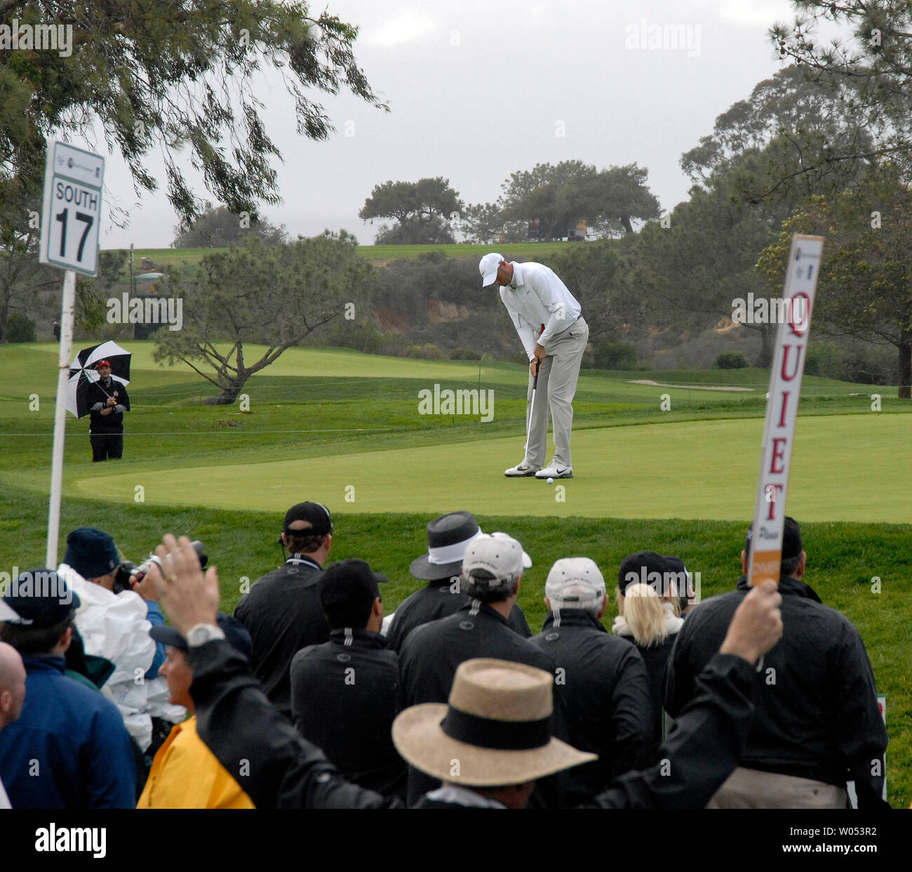 The gallery watches as golfer Stewart Cink putts the ball on the 17th ...
