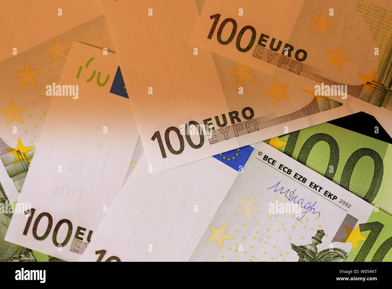 One hundred euro notes close up brown color toned Stock Photo - Alamy