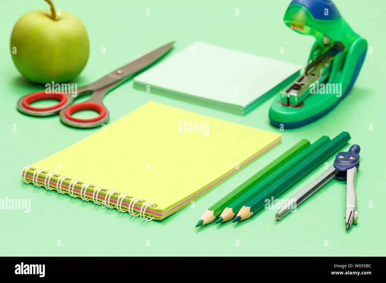 Compass, color pencils, notebook, note paper, stapler, apple and ...