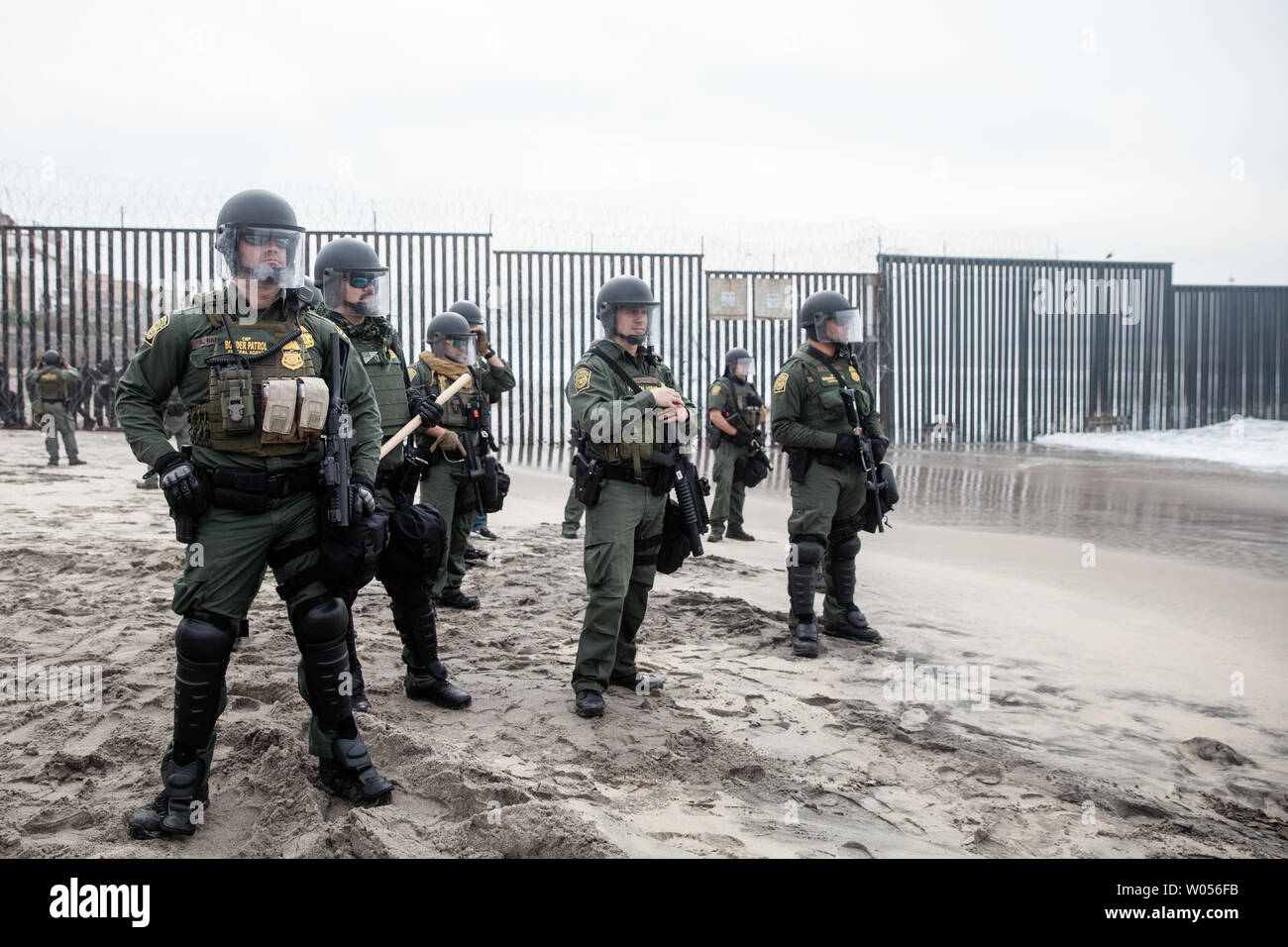Border Patrol agents wait for over 300 demonstrators walking towards ...