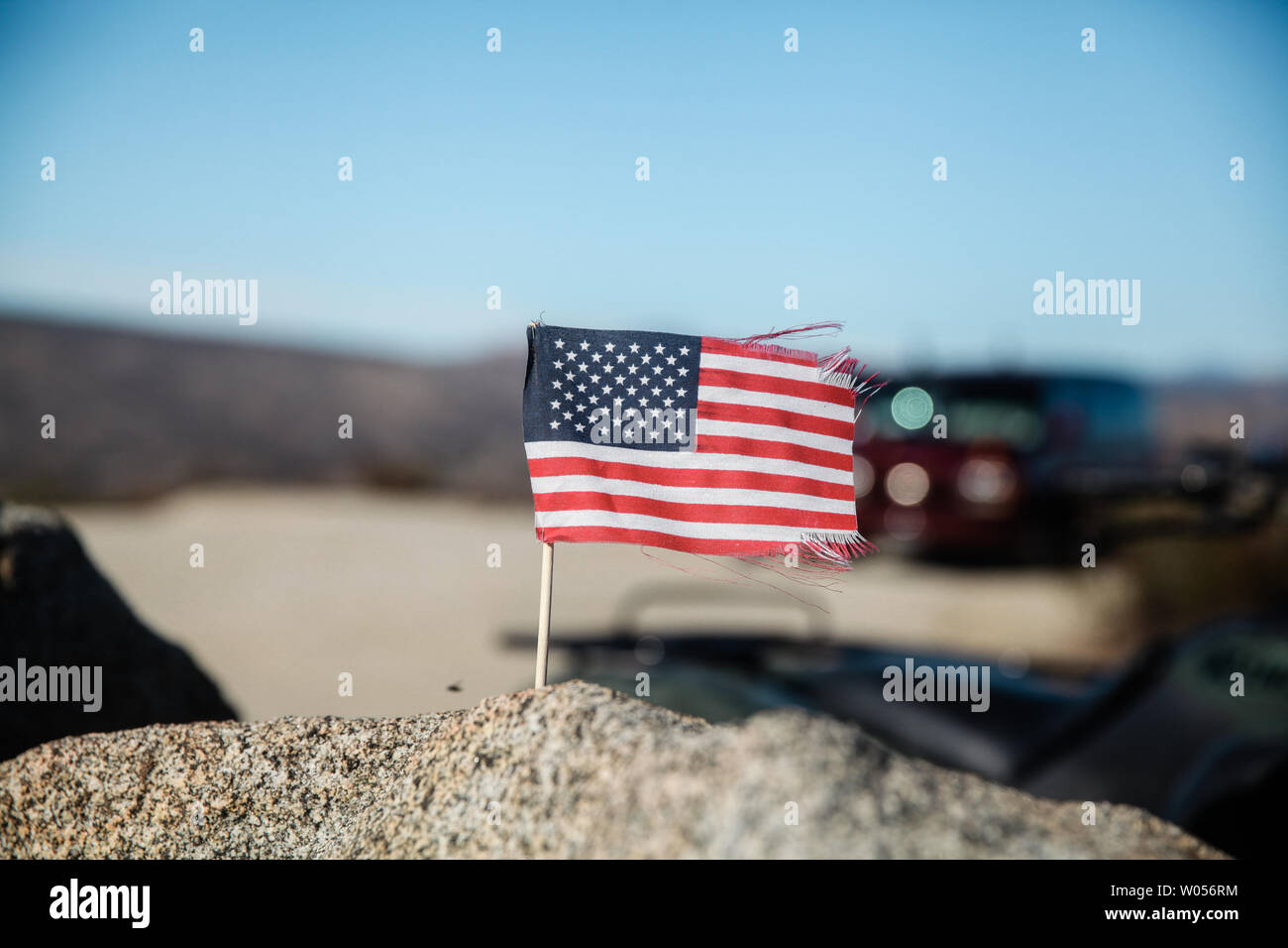 A miniature American flag sits on a hill in Campo, California on ...
