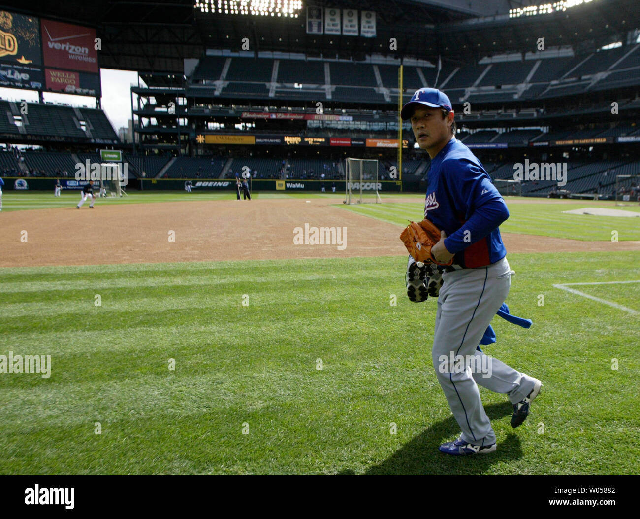 Texas Rangers pitcher Akinori Otuska, of Japan, runs off the field to ...