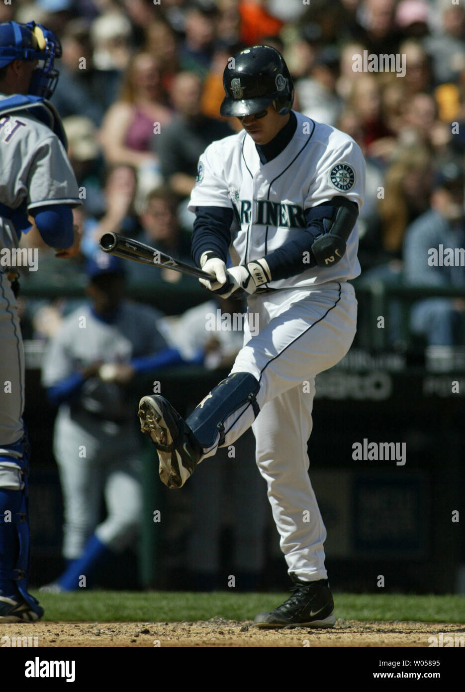 Seattle Mariners' Kenji Johjima kicks his bat in frustration after ...
