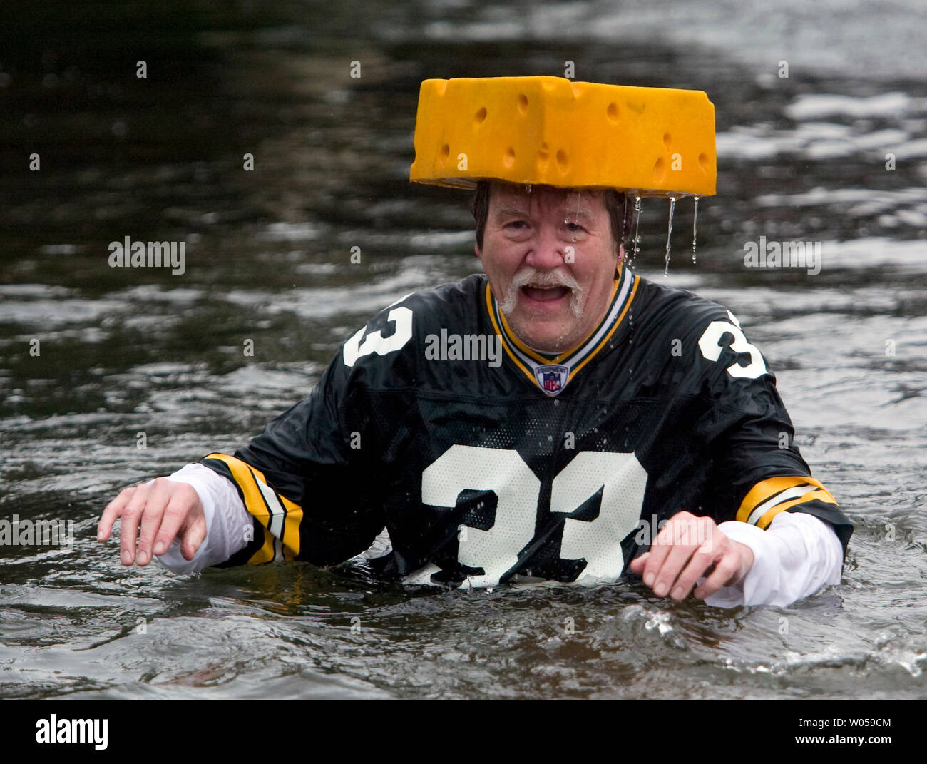 Water drips from Ken Kietter's cheesehead after he jumped into the ...
