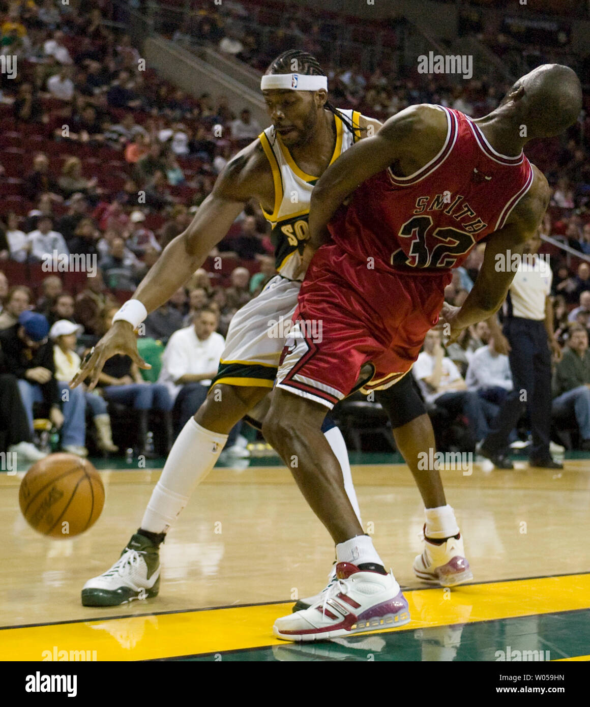 Chicago Bulls' Joe Smith (R) is knocked over by Seattle SuperSonics ...