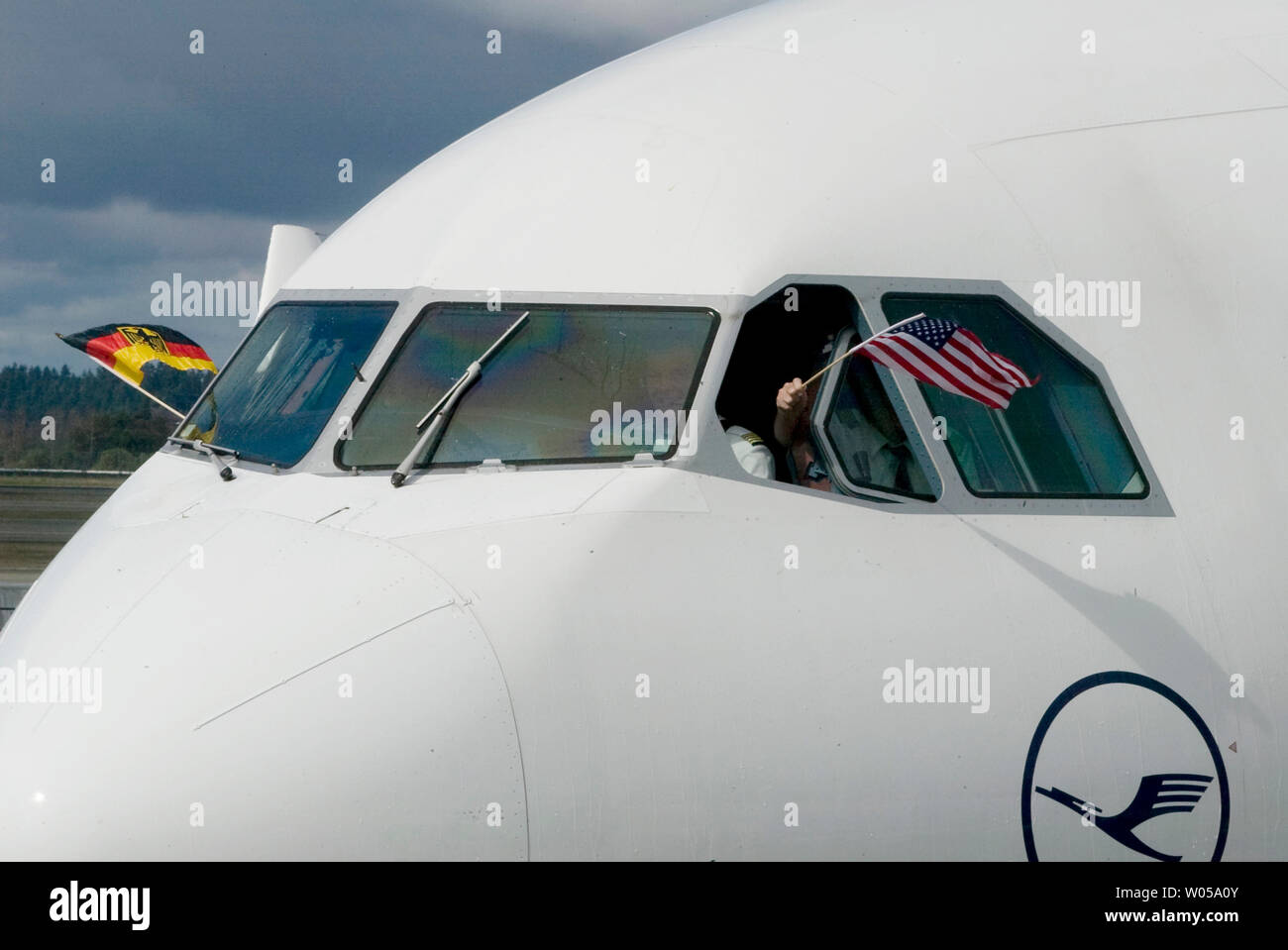 Pilot Karl Ulrich Garnadt displays the American flag out of the cockpit ...