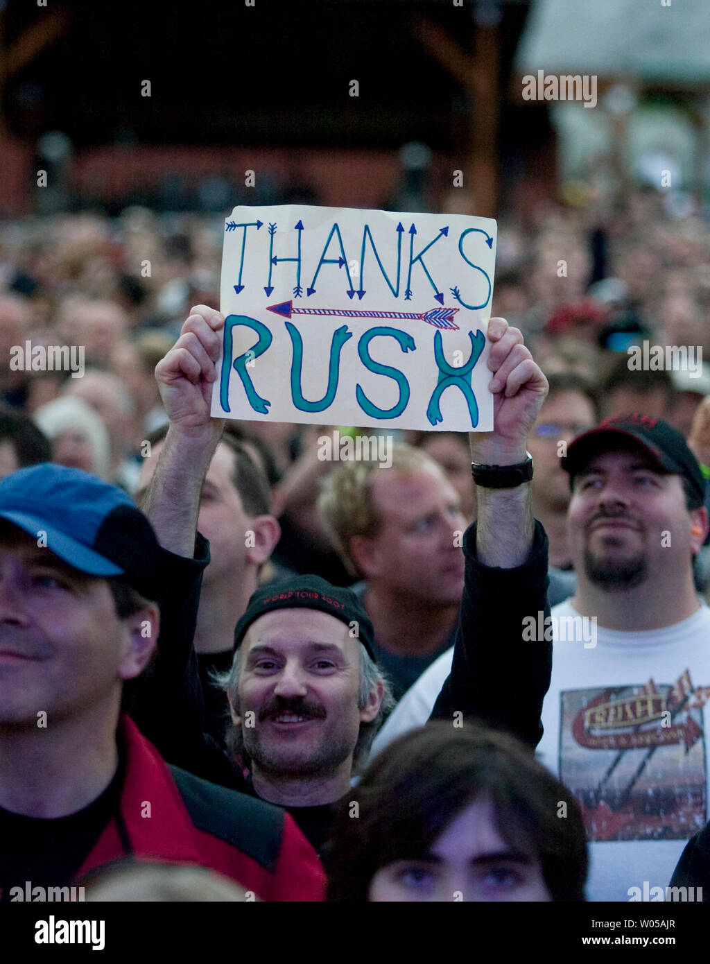 A Rush fan waves a sign during their Snakes and Arrows tour at the ...
