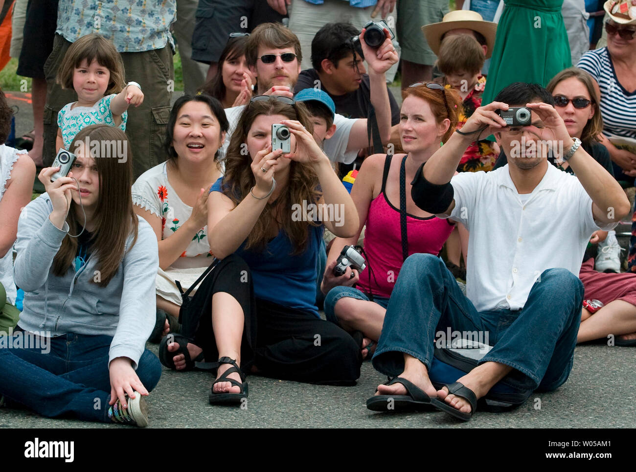 Photographers take pictures of bicycle riders during the 20th Annual ...
