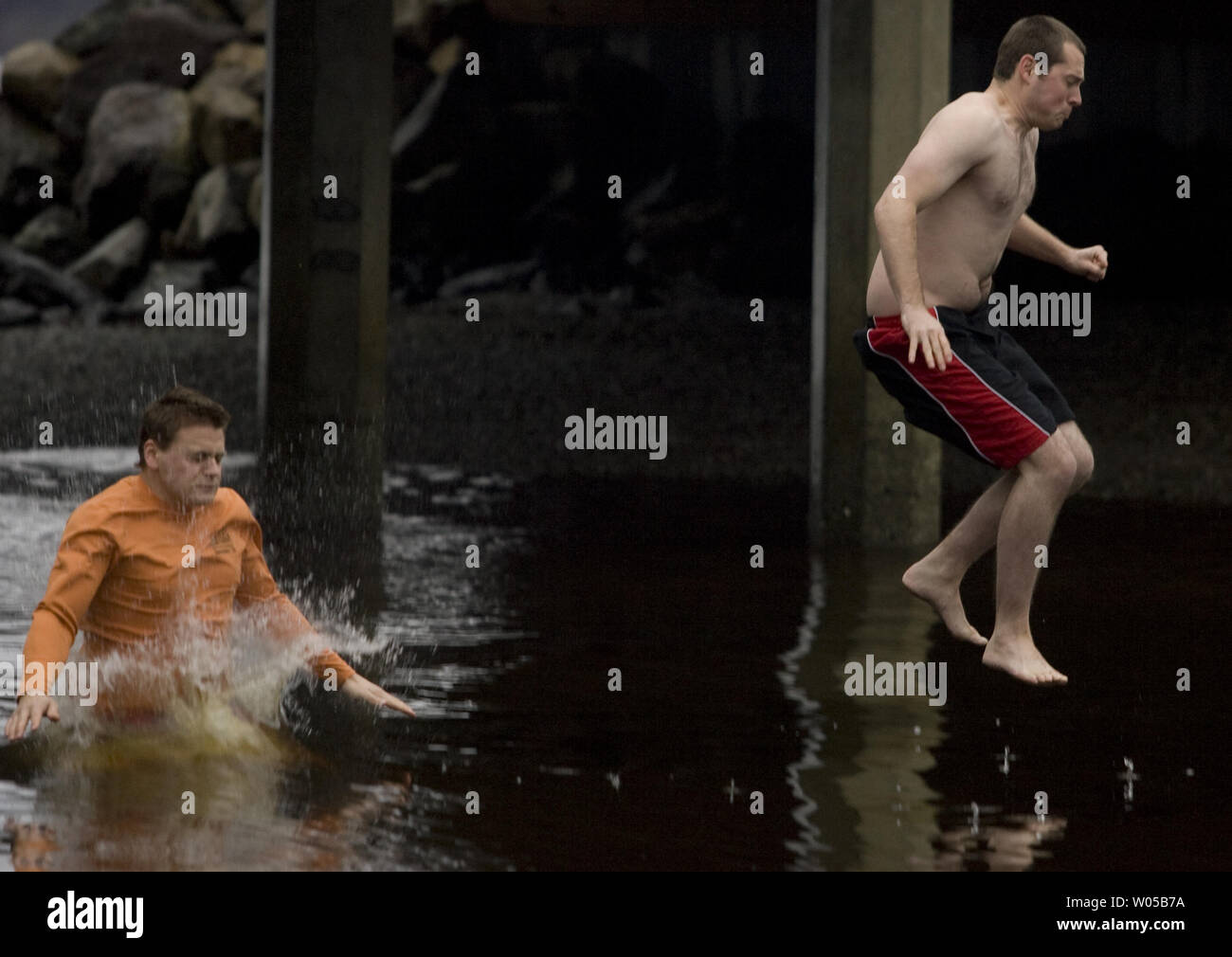Tacoma residents Ryan Privett (L) hits the water before Christopher ...