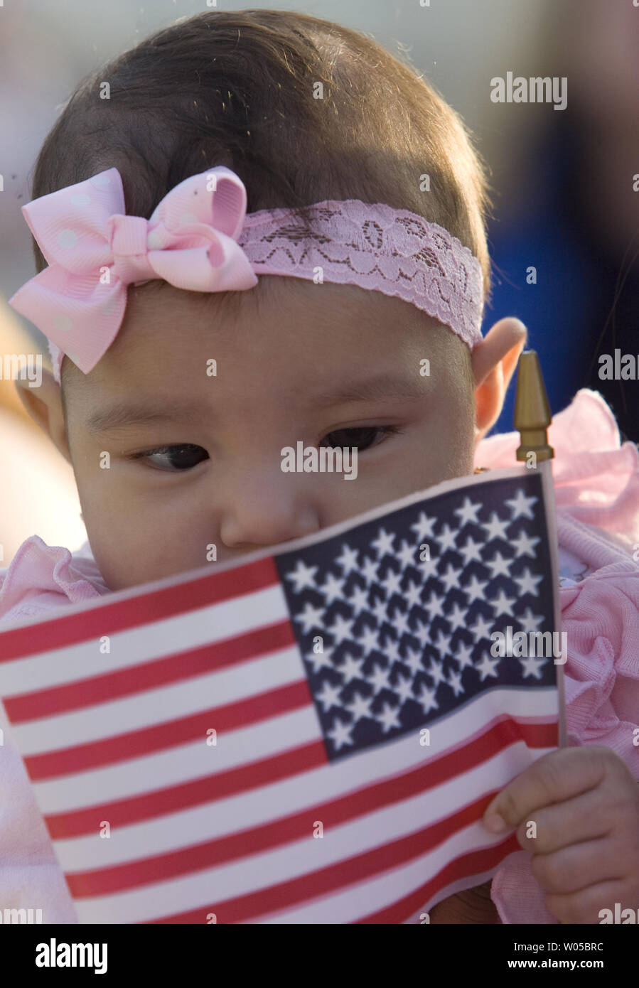 Three-month-old Natalissa Arambul looks at a U.S. flag as the USS John ...