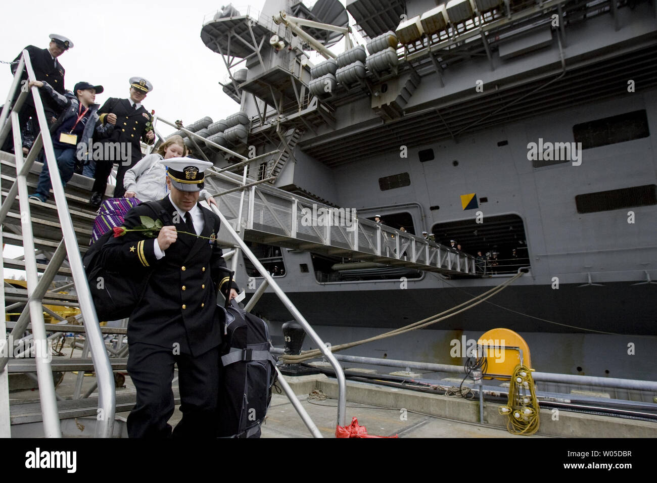 Lt. Patrick Emery walks down the brow of the USS John C. Stennis after ...