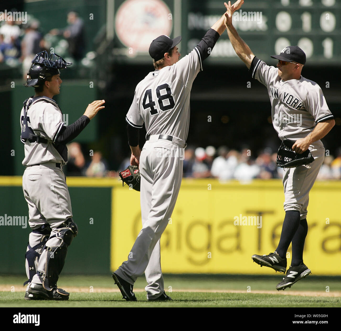 New York Yankees' reliever Andrew Miller, center, high fives outfielder ...