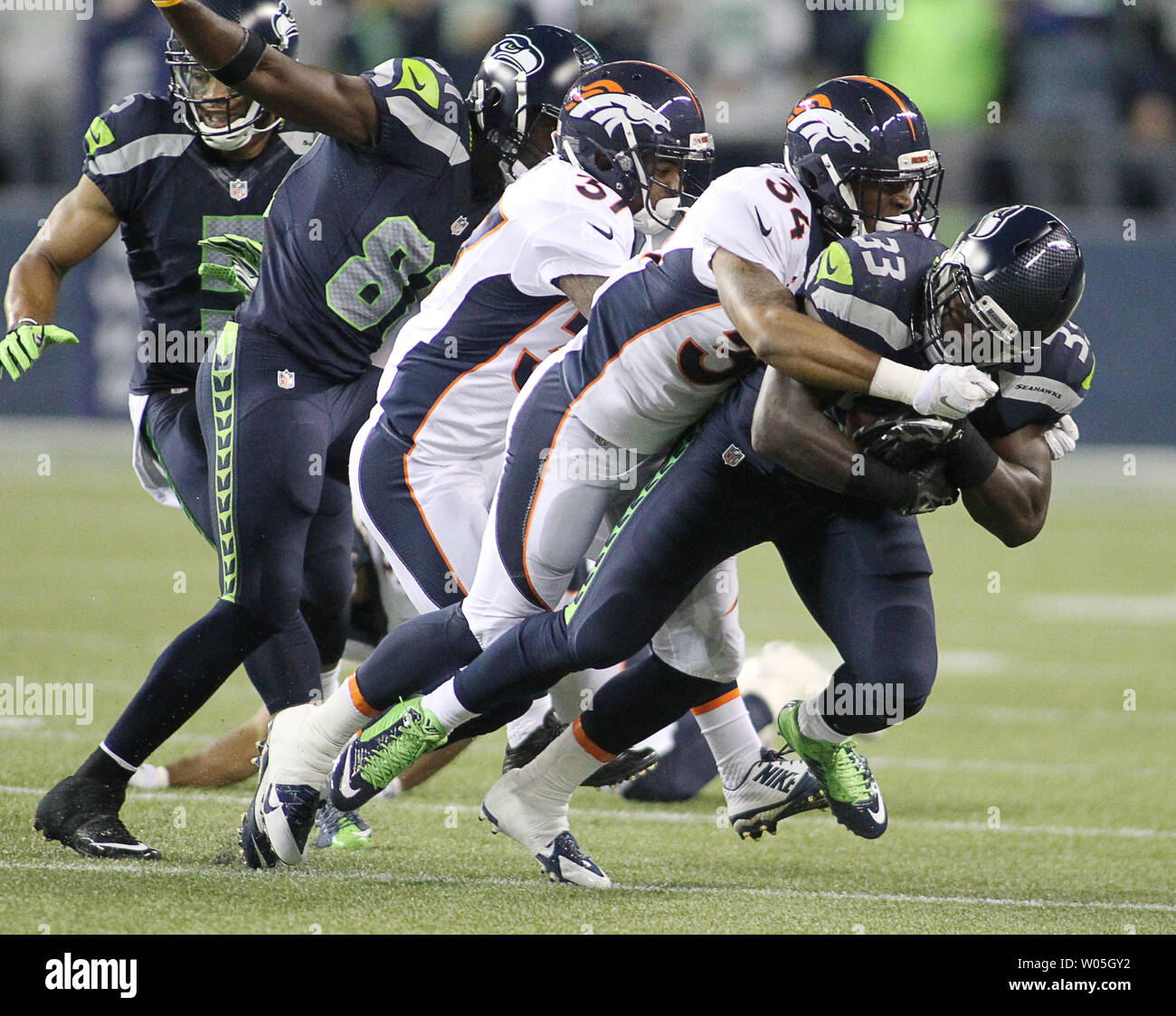 Seattle Seahawks running back Christine Michael (33) is brought down by ...