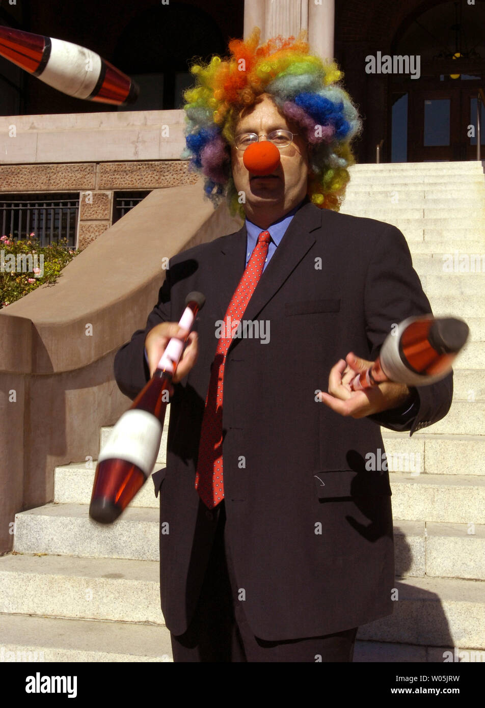 Kenneth Kahn, aka "Kenny the Clown," takes a moment in front of Alameda ...
