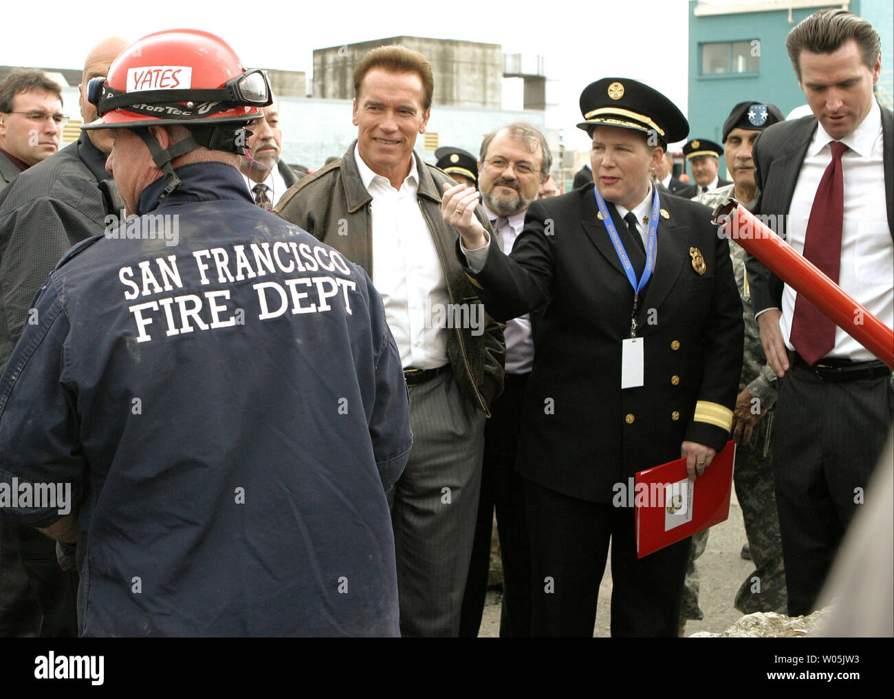 Governor Arnold Schwarzenegger listens to local firefighters during the ...