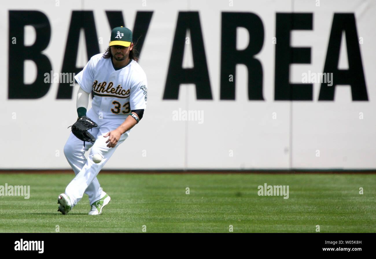 Oakland Athletics center fielder Nick Swisher (33) fields a ball hit to ...