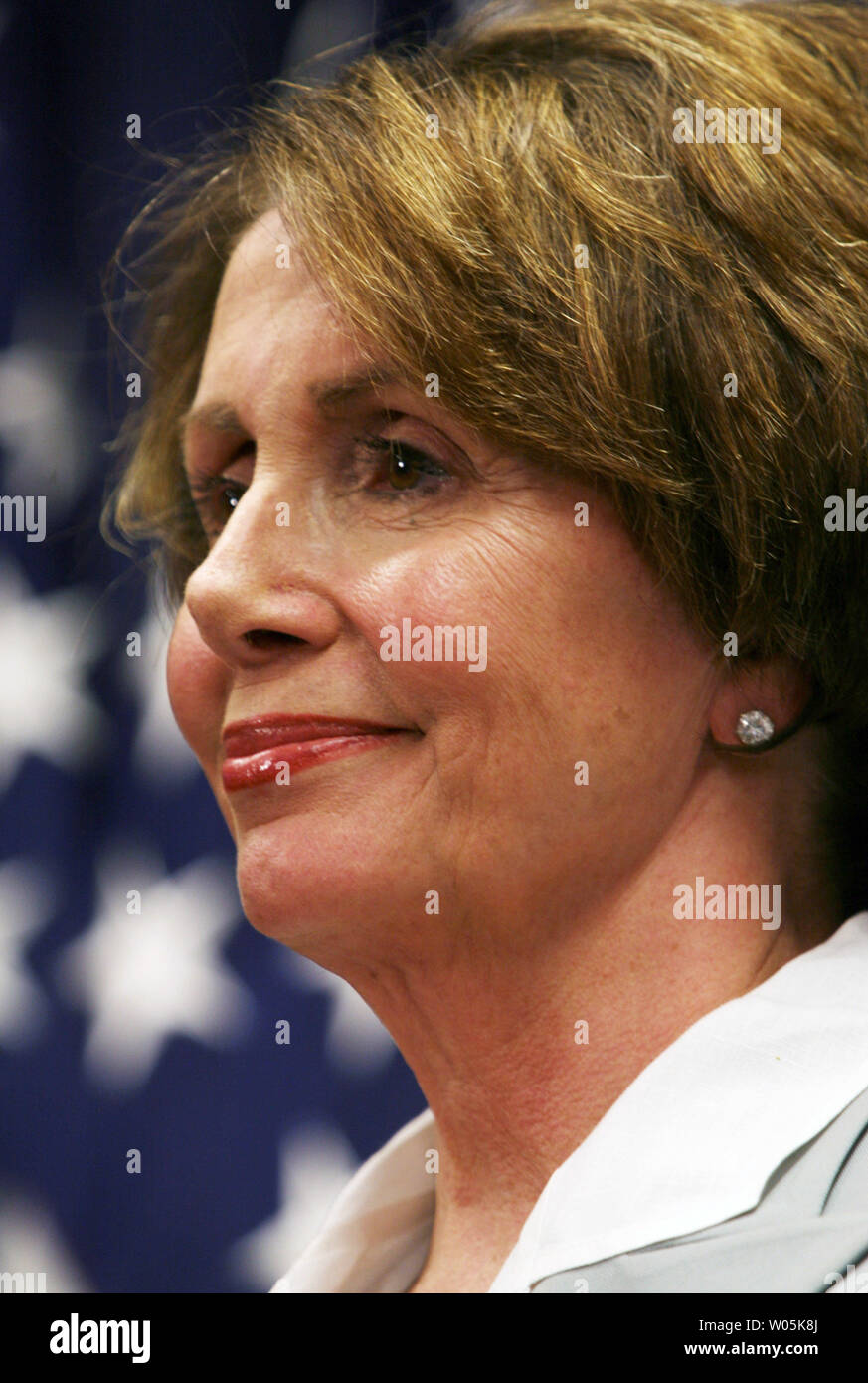 Speaker of the House Nancy Pelosi (D-CA) smiles while listening to Rep ...
