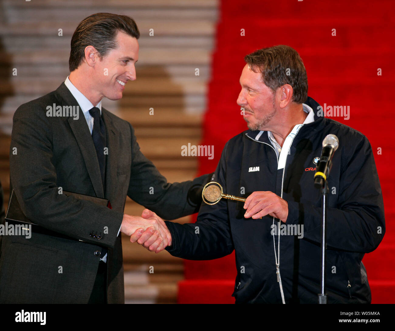 San Francisco Mayor Gavin Newsom (L) gives Oracle CEO Larry Ellison ...